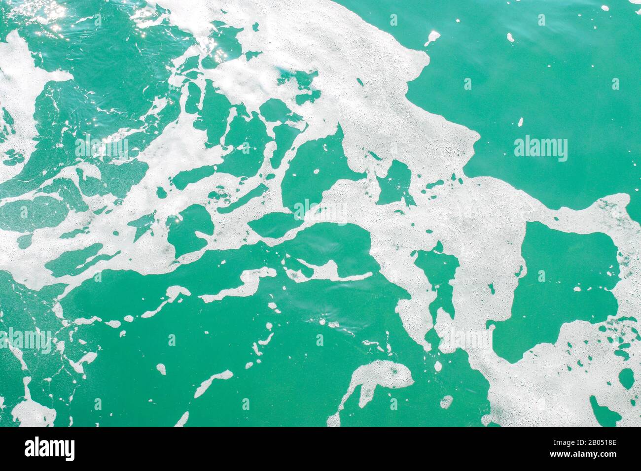Turquoise sea water with foam. Abstract sea background. Ocean waves ...