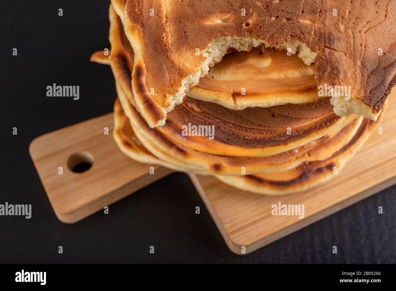 One cake bitten off a stack of other pancakes. Tasty cookies on the ...