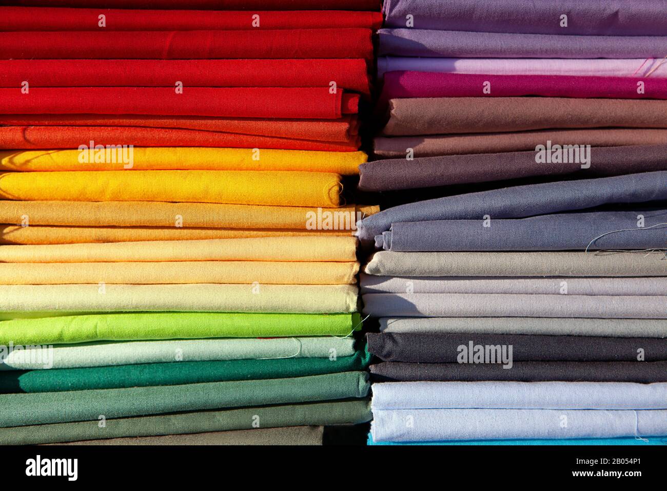 pile of colorful fabrics background Stock Photo - Alamy