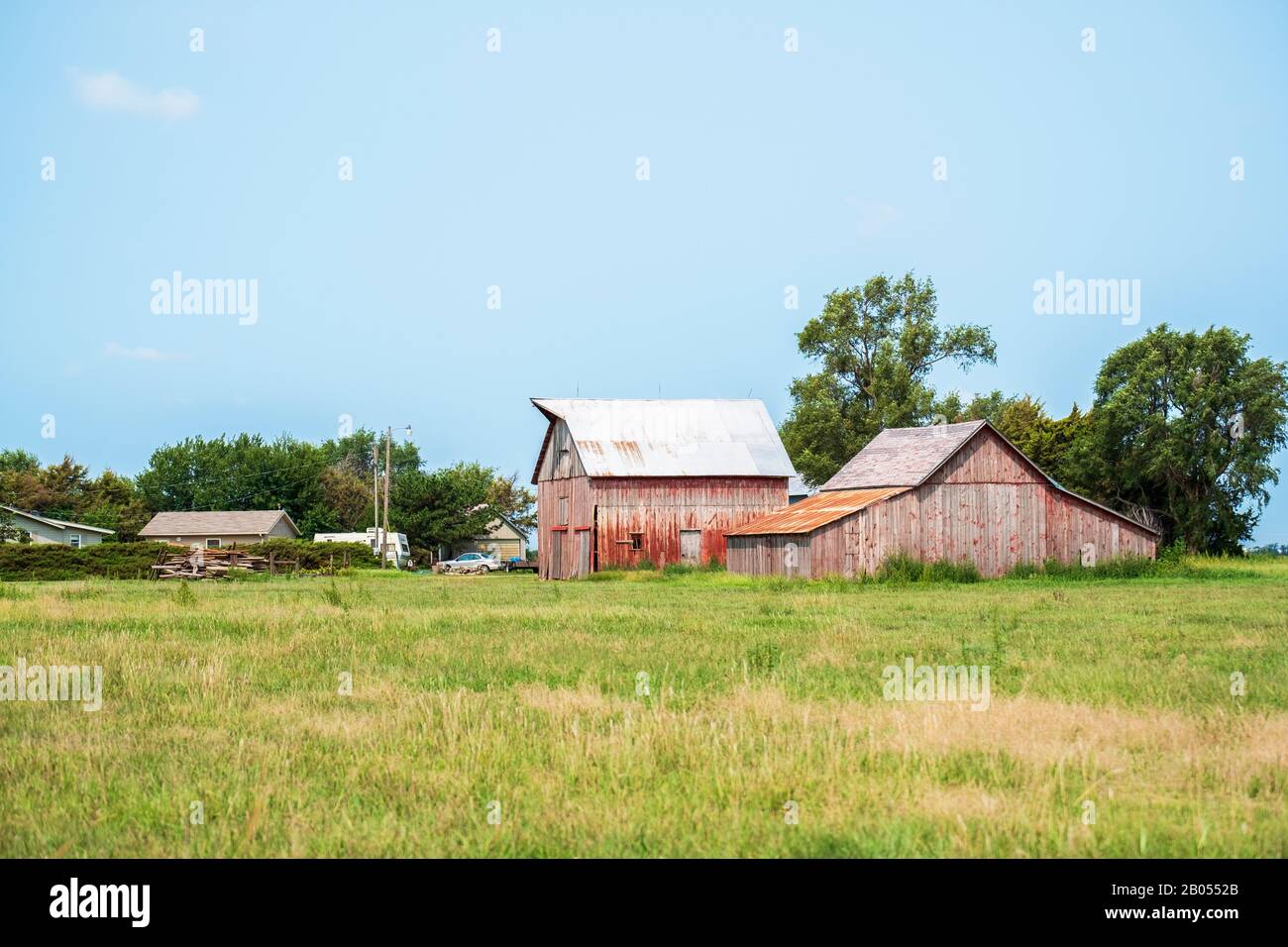 Kansas farm with grass pasture and wooden barns and outbuildings with ...