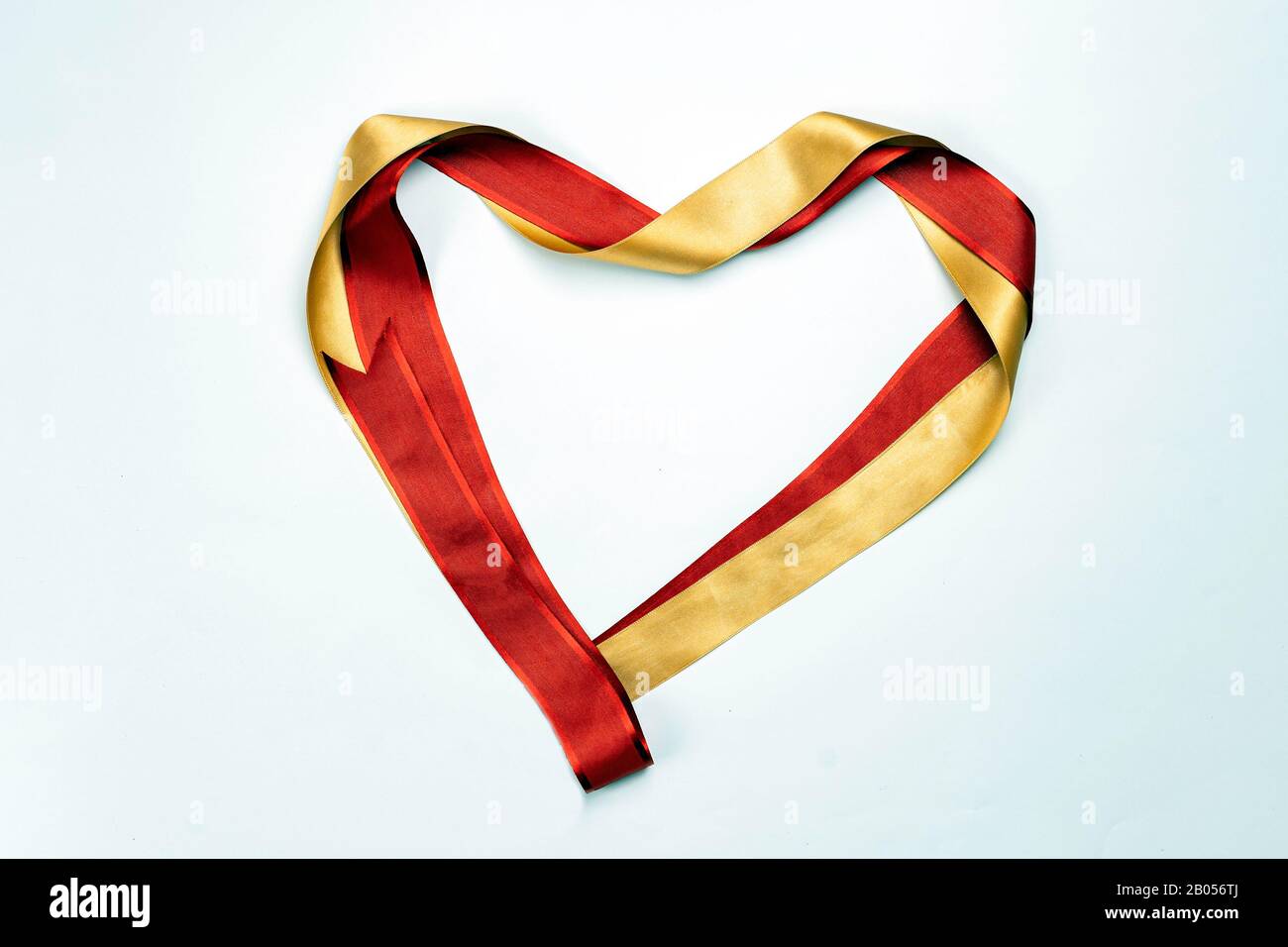Red heart shaped ribbon isolated on white background Stock Photo - Alamy