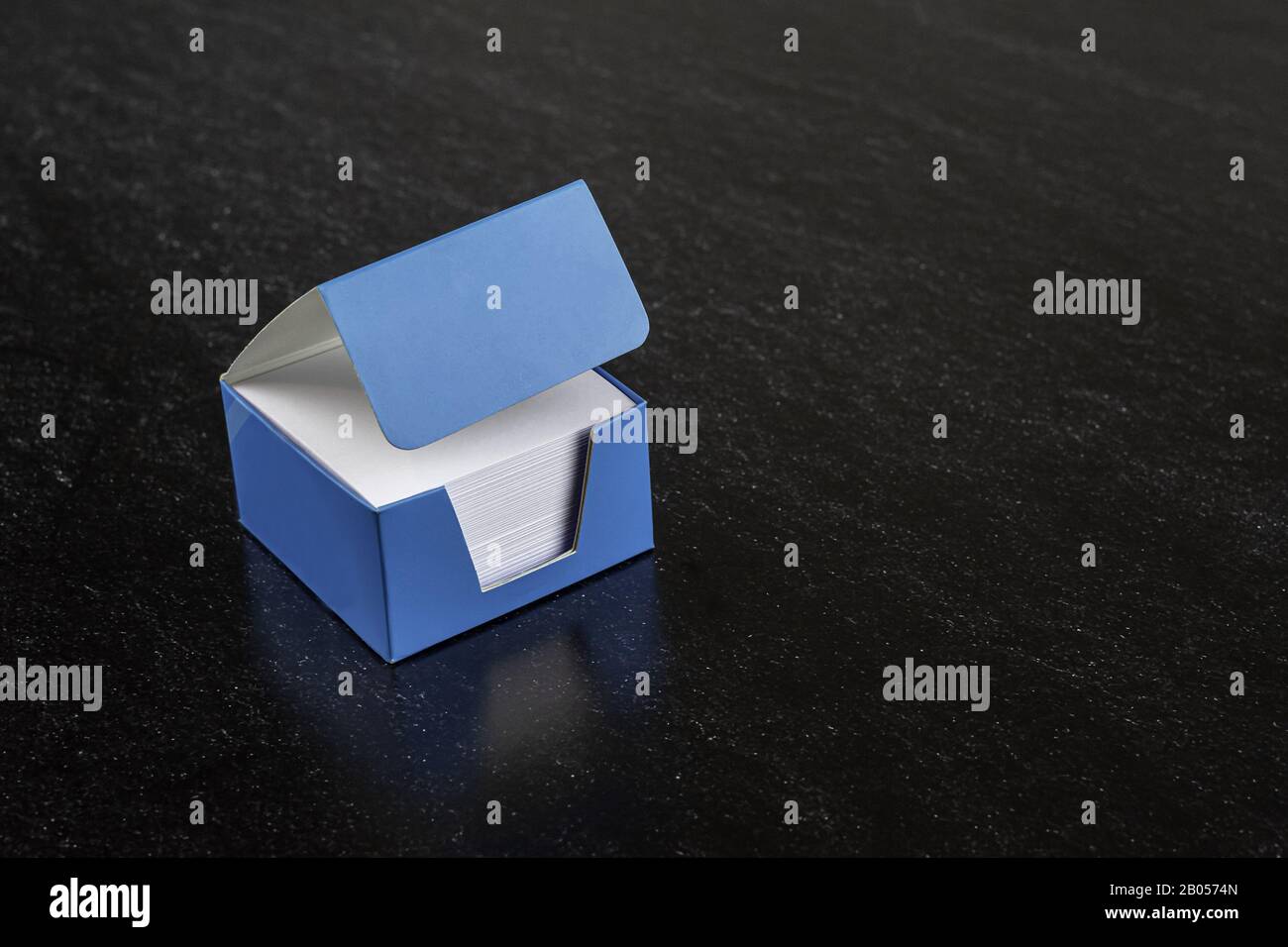 blue Box Of white memo papers on dark background mock up. office note ...