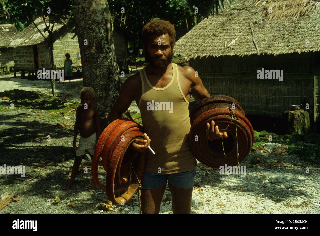 SOLOMON ISLANDS, NENDO ISLAND, NATIVE WITH TRADITIONAL FEATHER MONEY ...