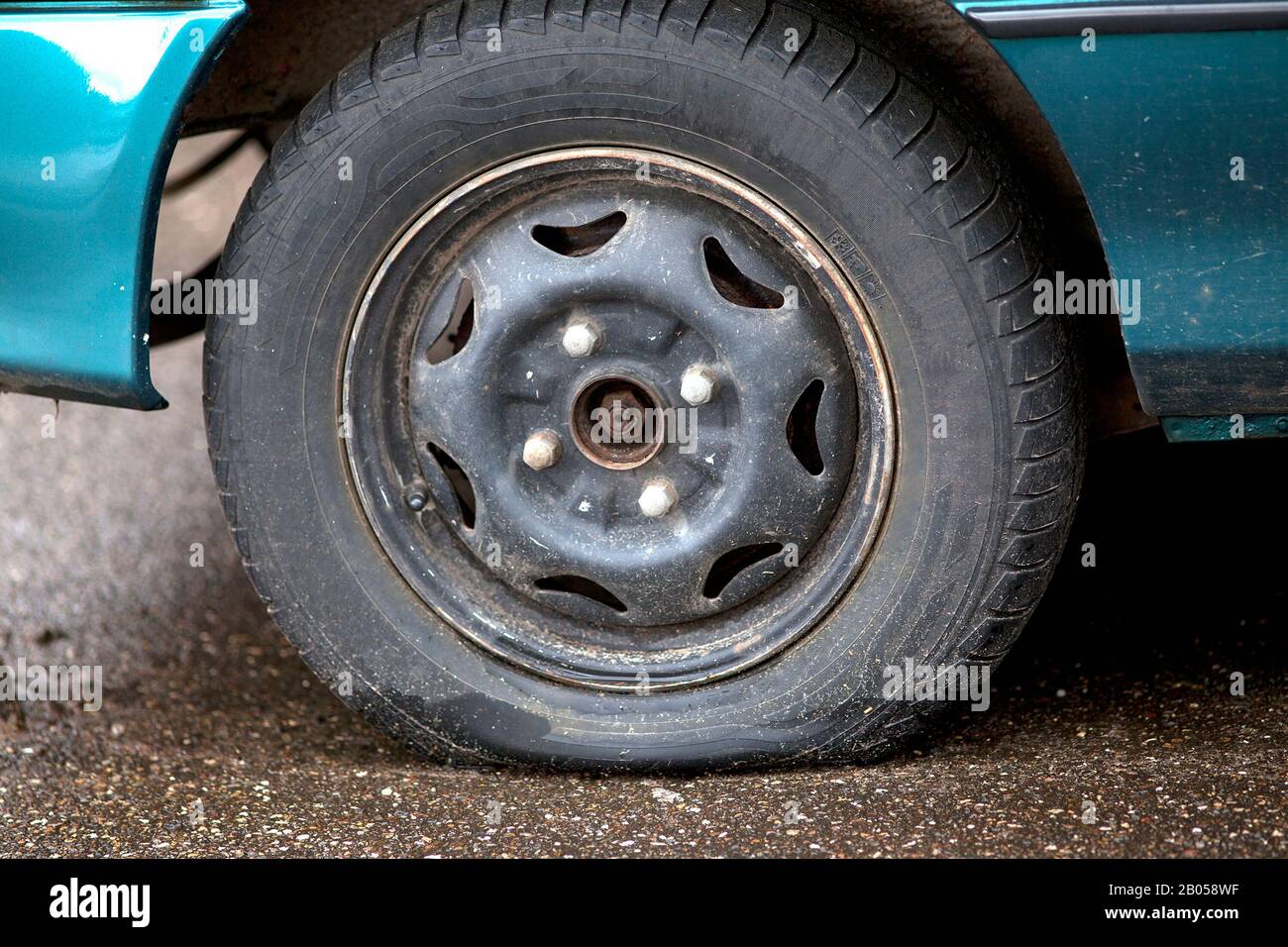 flat tire, damaged wheel on car lost aerial Stock Photo - Alamy