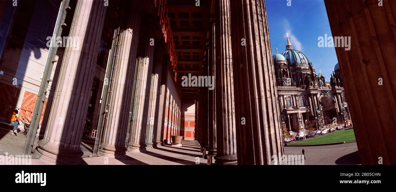 Colonnade of a museum with a cathedral in the background, Altes Museum ...