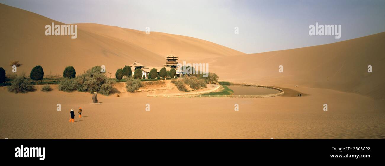 Pagoda and a lake in a desert, Crescent Lake, Dunhuang, Jiuquan, Gansu ...