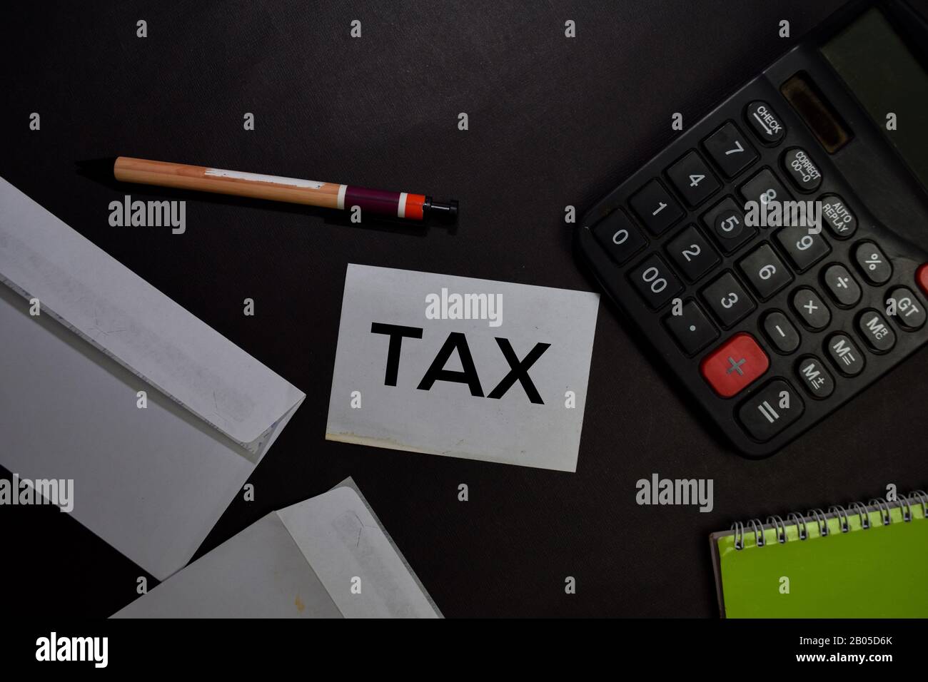 Tax write on a sticky note isolated on office desk Stock Photo - Alamy