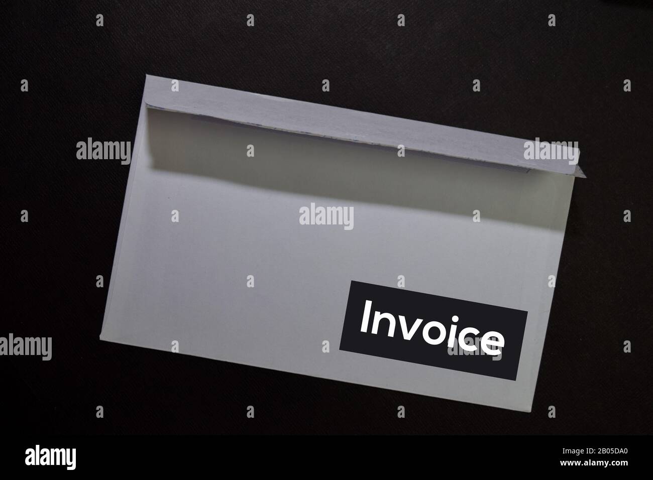 Invoice write on a white envelope isolated on office desk Stock Photo ...