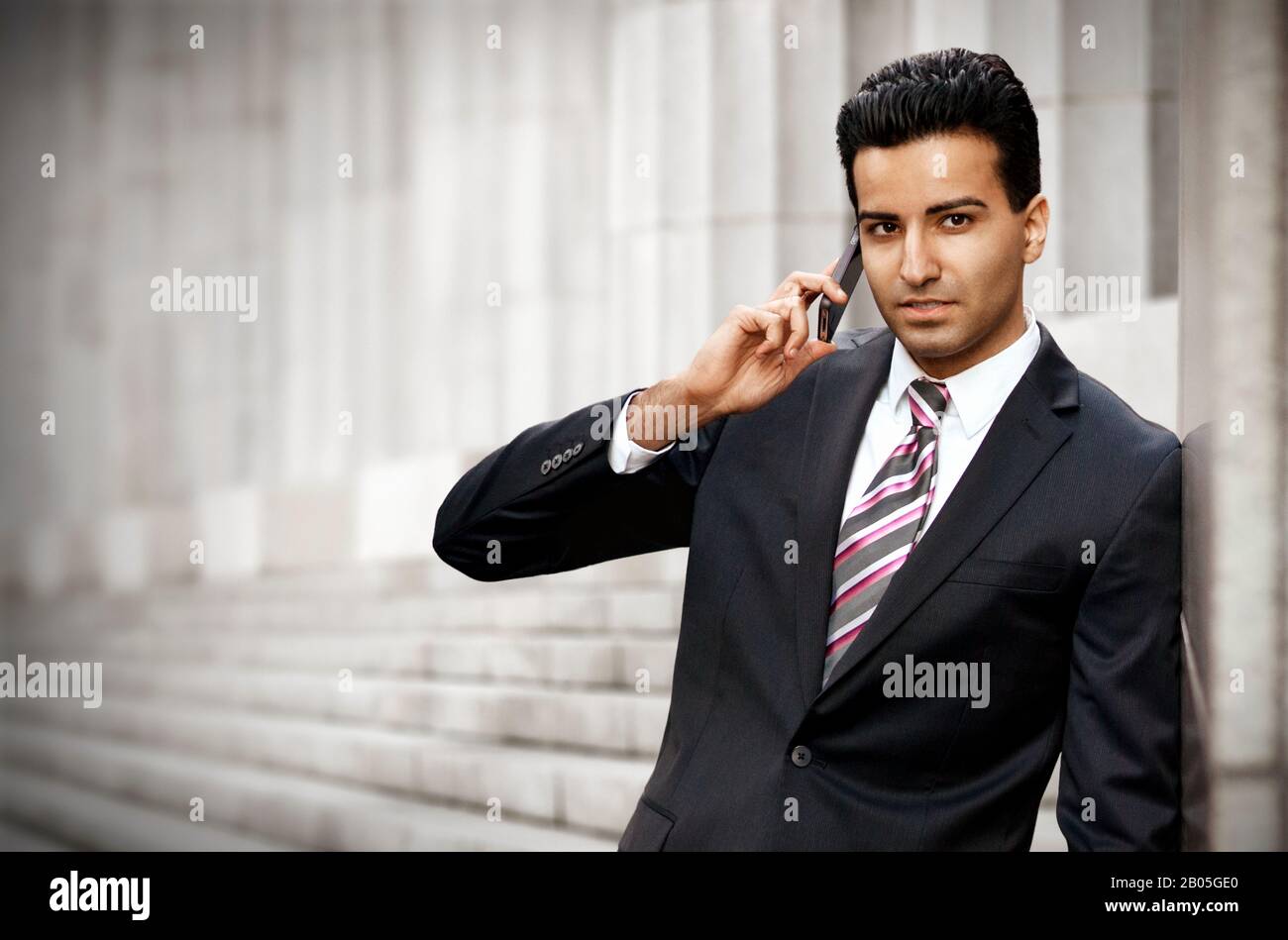 Portrait of a savvy young lawyer taking an important phone call outside ...