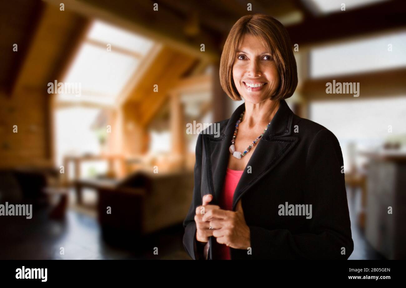 Portrait of a smiling real estate agent inside a house Stock Photo - Alamy