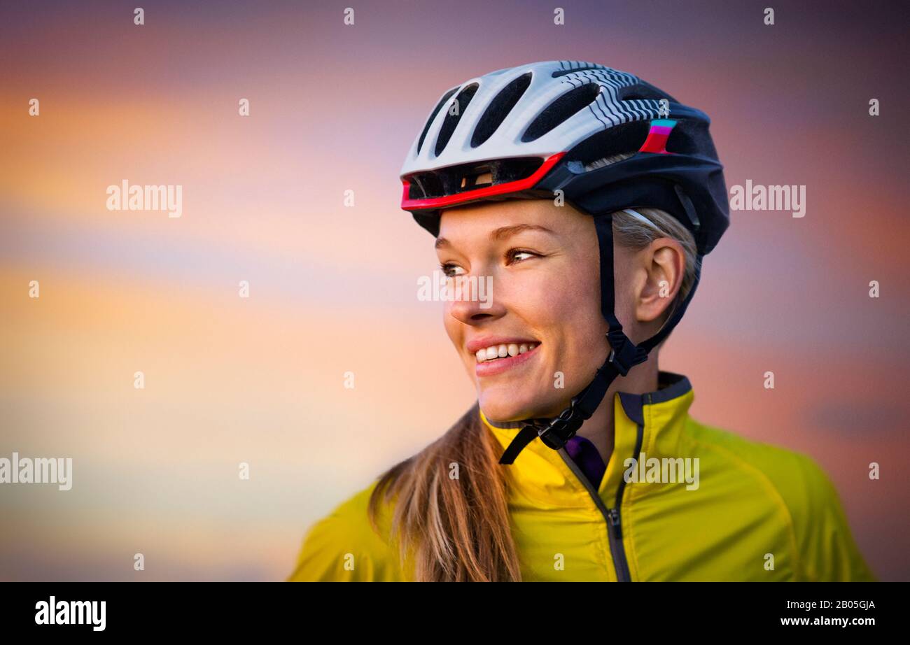 Portrait of a happy young female cyclist Stock Photo - Alamy