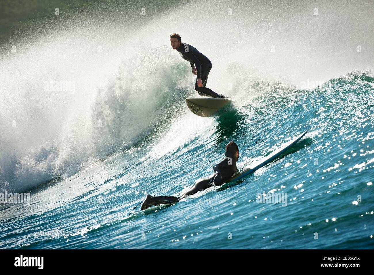Two surfers in the water together Stock Photo - Alamy