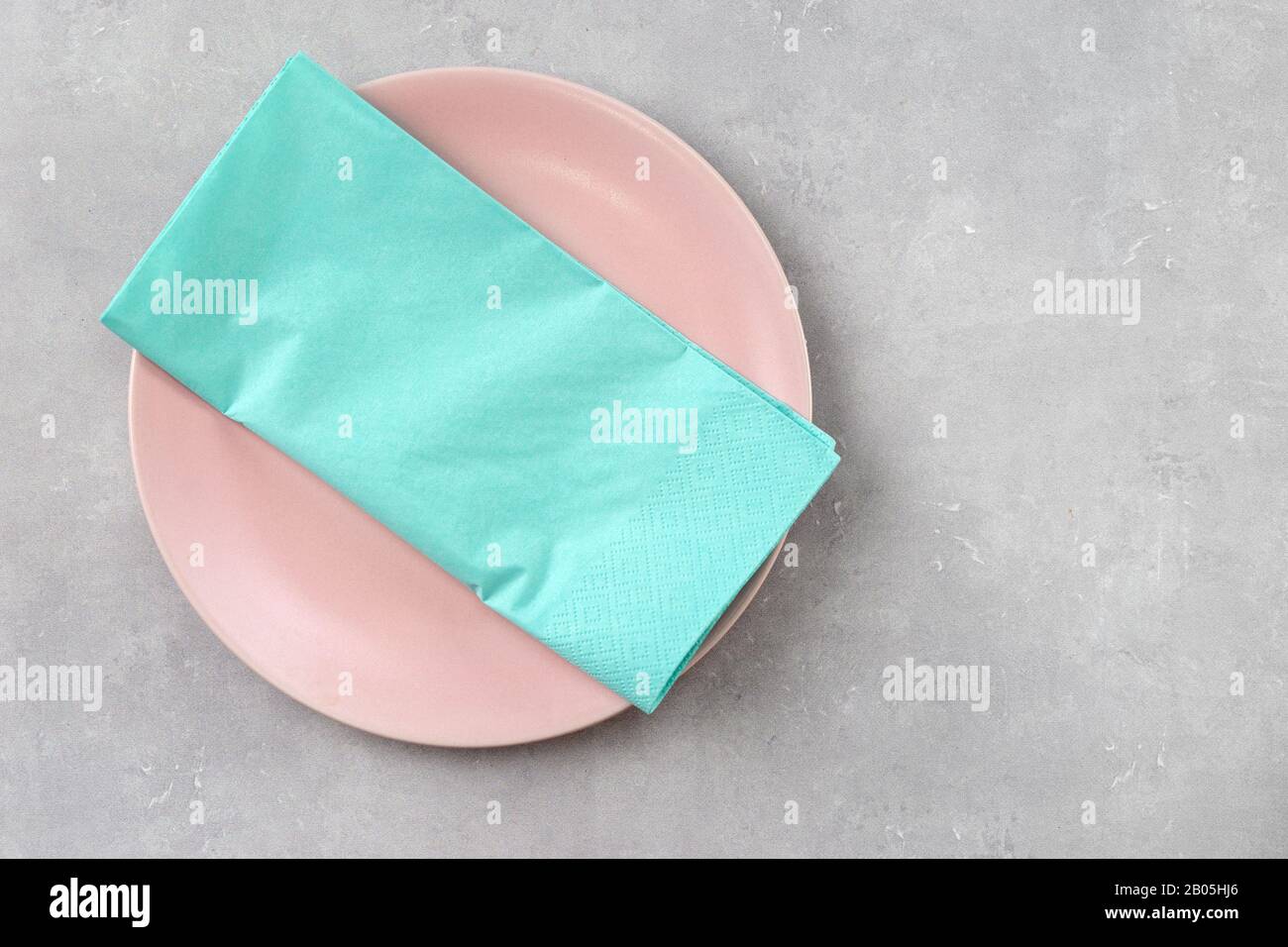 Top view of pink plate with mint color serviette Stock Photo - Alamy