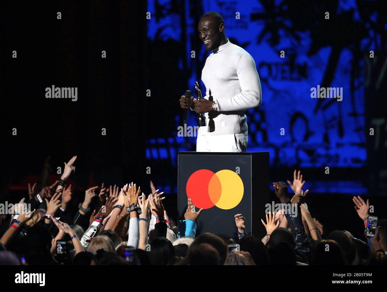 Stormzy with his Male Solo Artist award on stage at the Brit Awards ...