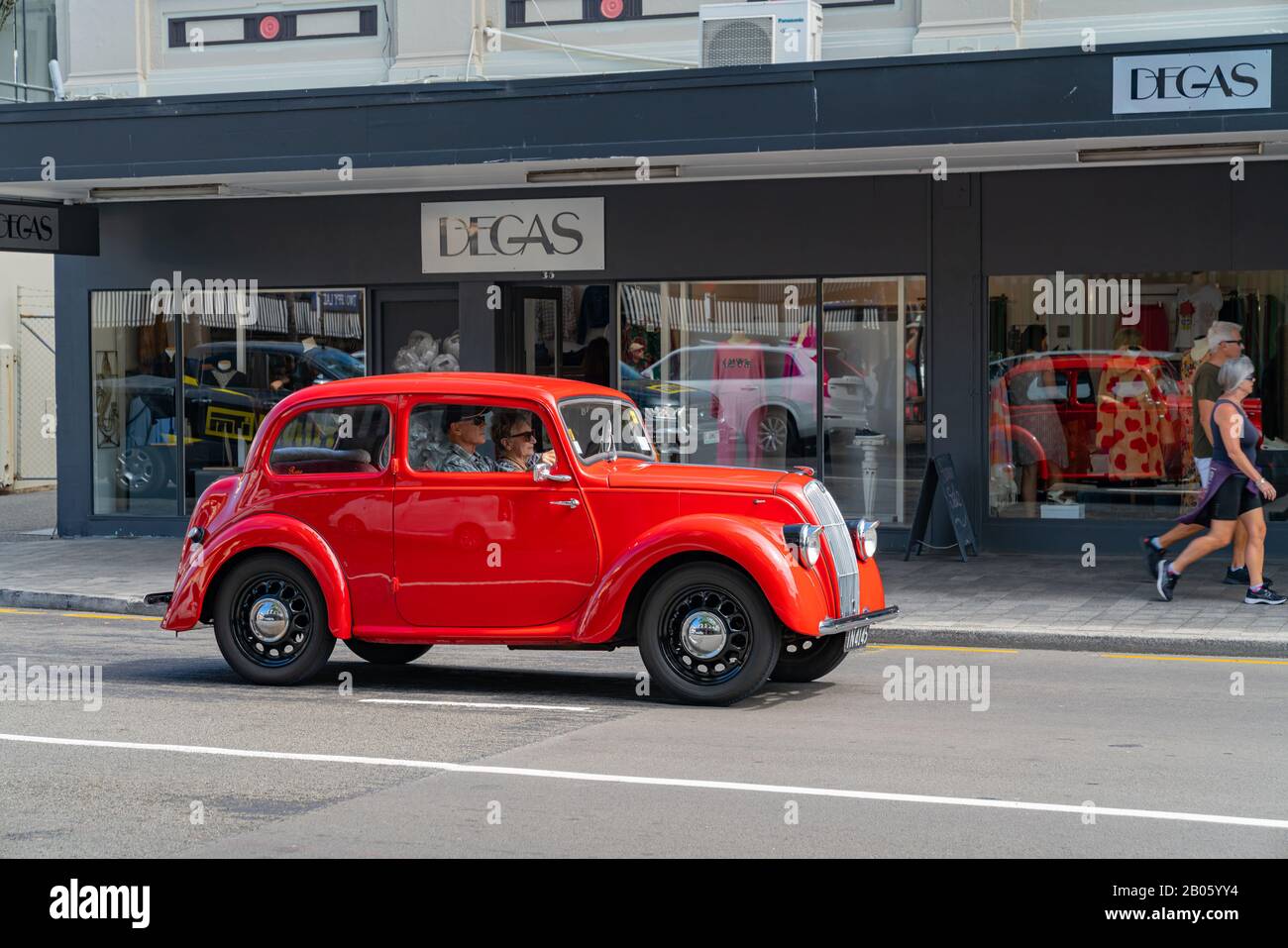 Napier - New Zealand - February 16 2020; Bright red Morris 8 car passes ...