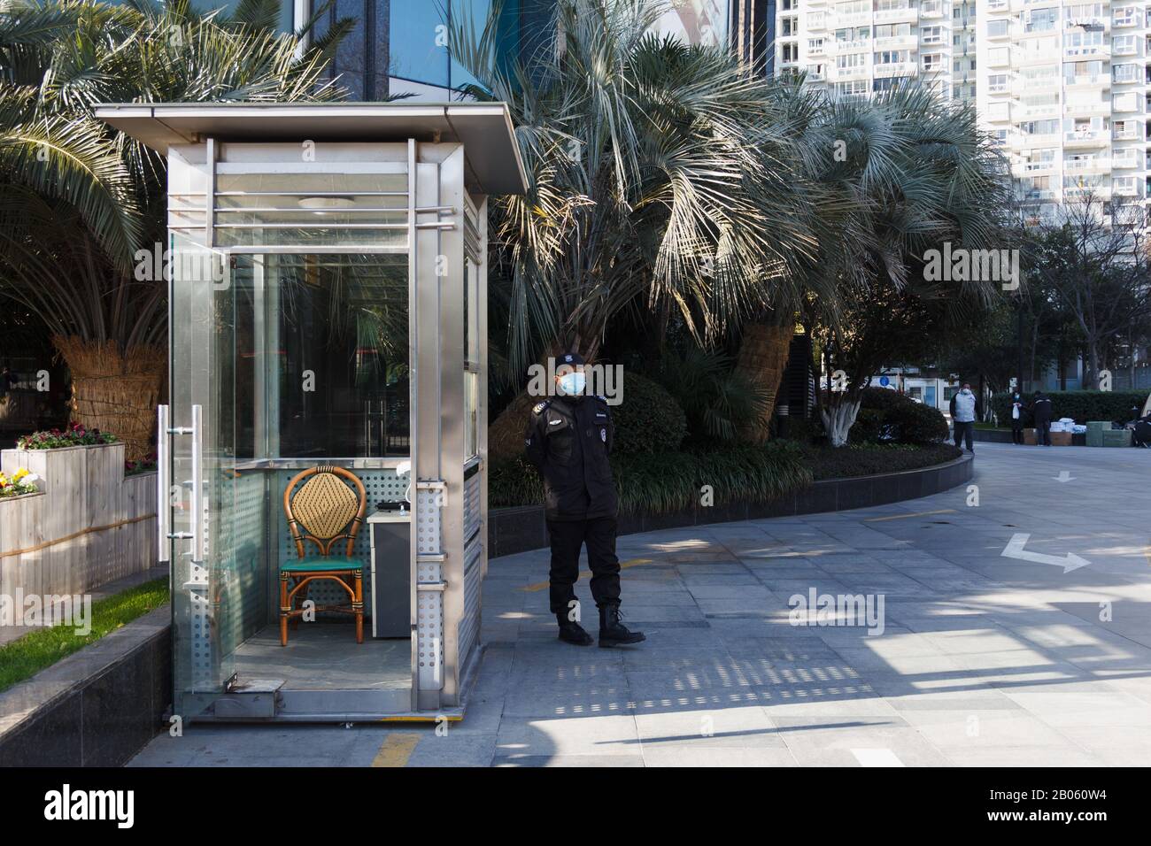 Guard with a mask at residential estate entrance Stock Photo - Alamy