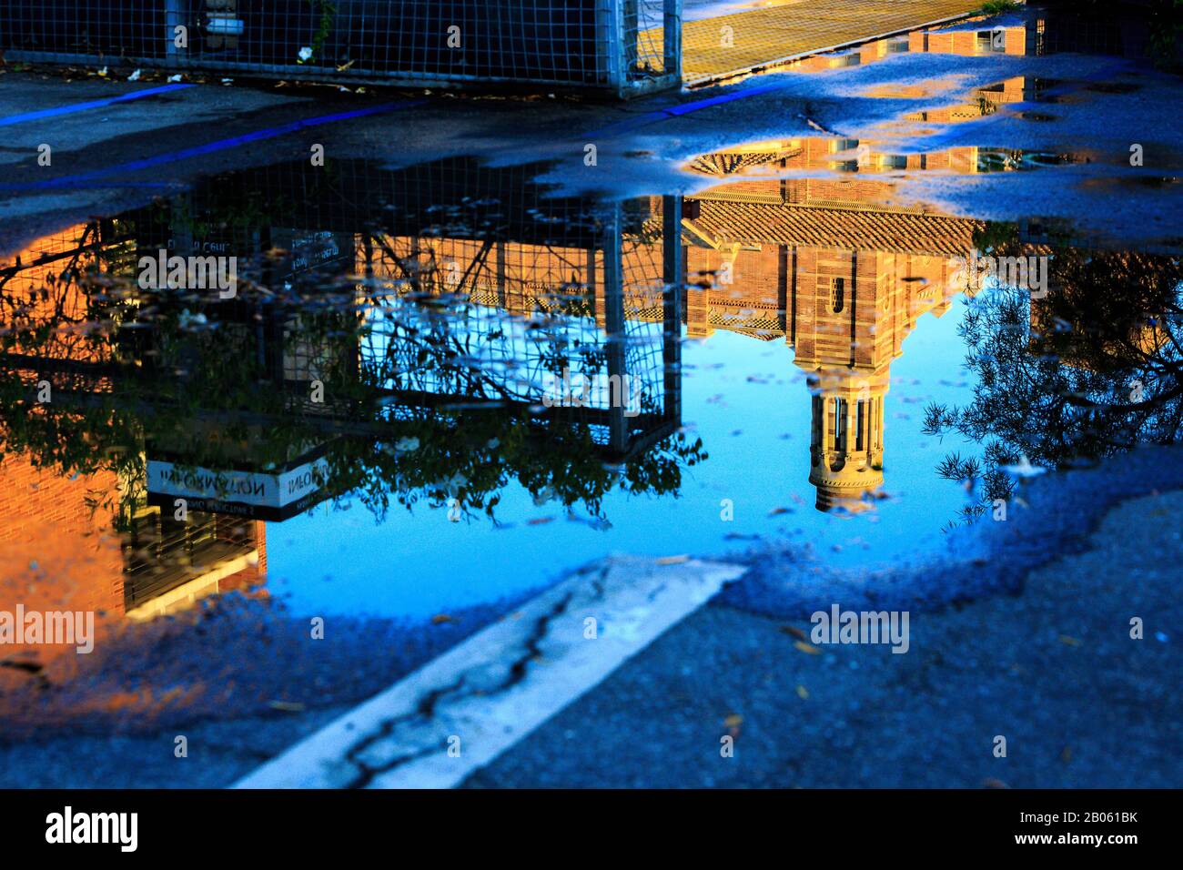 Building Reflection in Water on Asphalt of University College Stock ...