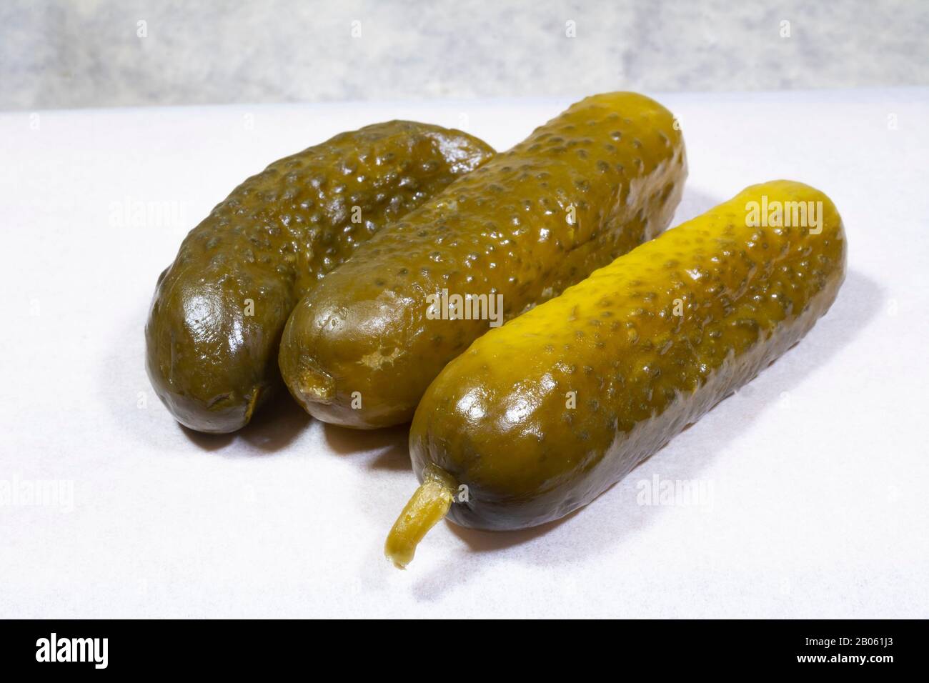 Three whole Russian pickled cucumbers Stock Photo - Alamy