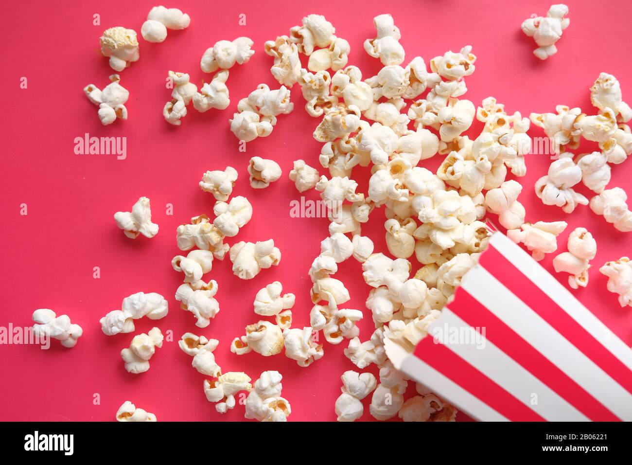 top view of popcorn on red background, spilling Stock Photo - Alamy