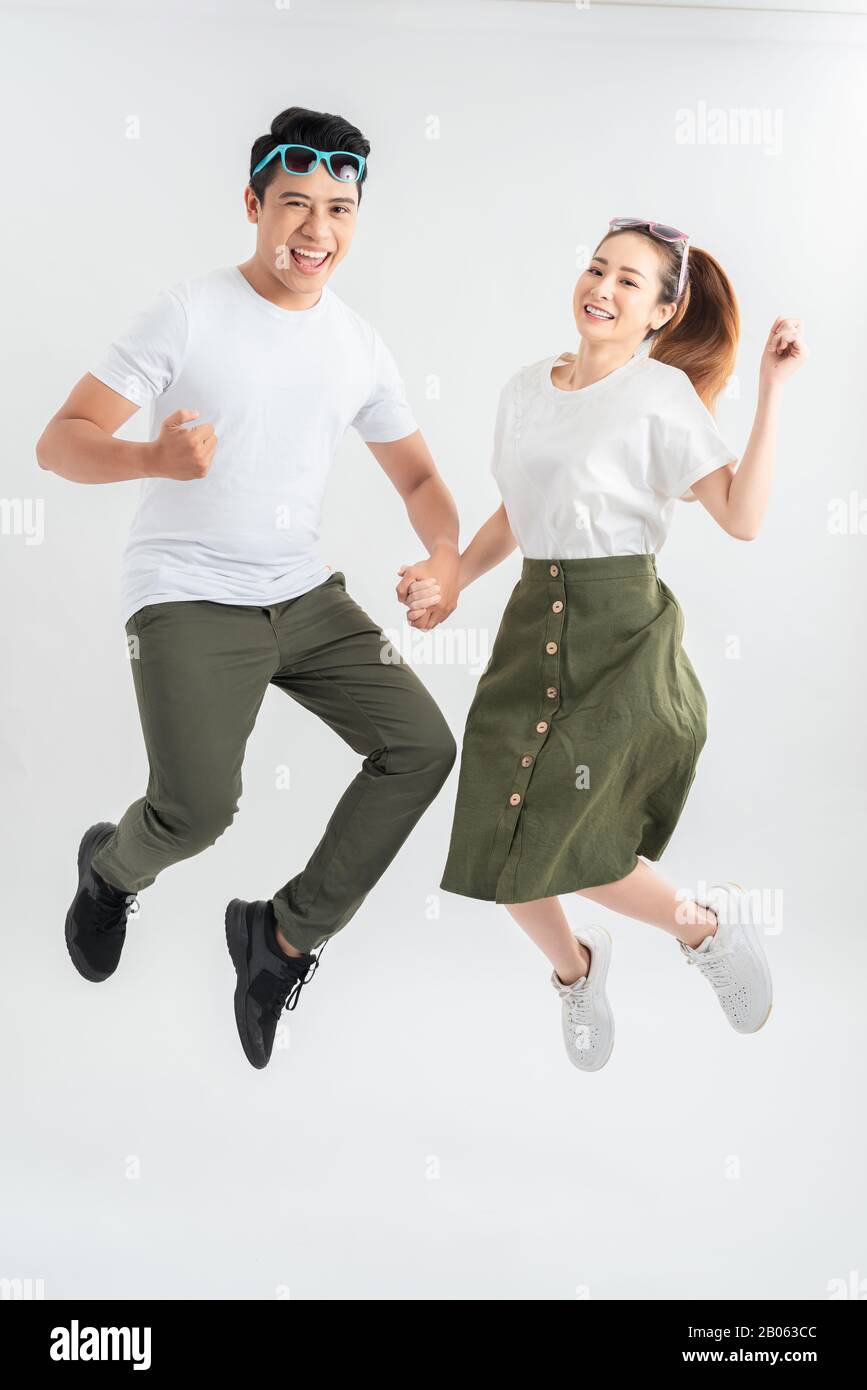 Full length shot of jumping couple having fun together Stock Photo - Alamy
