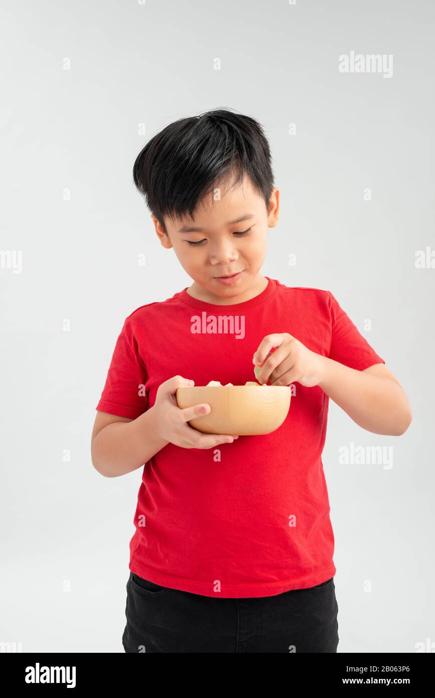 Smiling child with colored sweets and jelly candies on a white ...