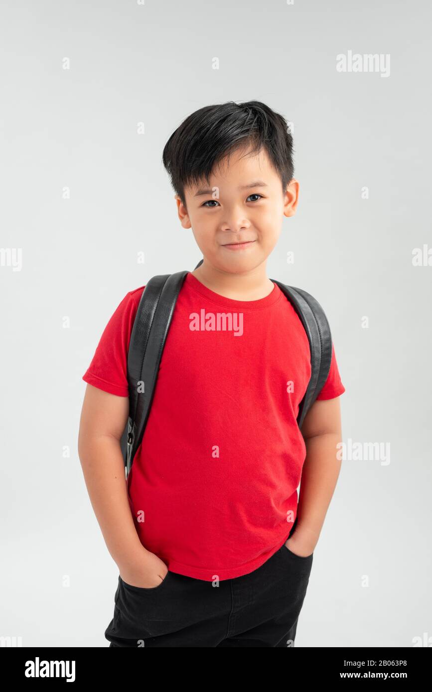 Confident little boy wearing backpack Stock Photo - Alamy