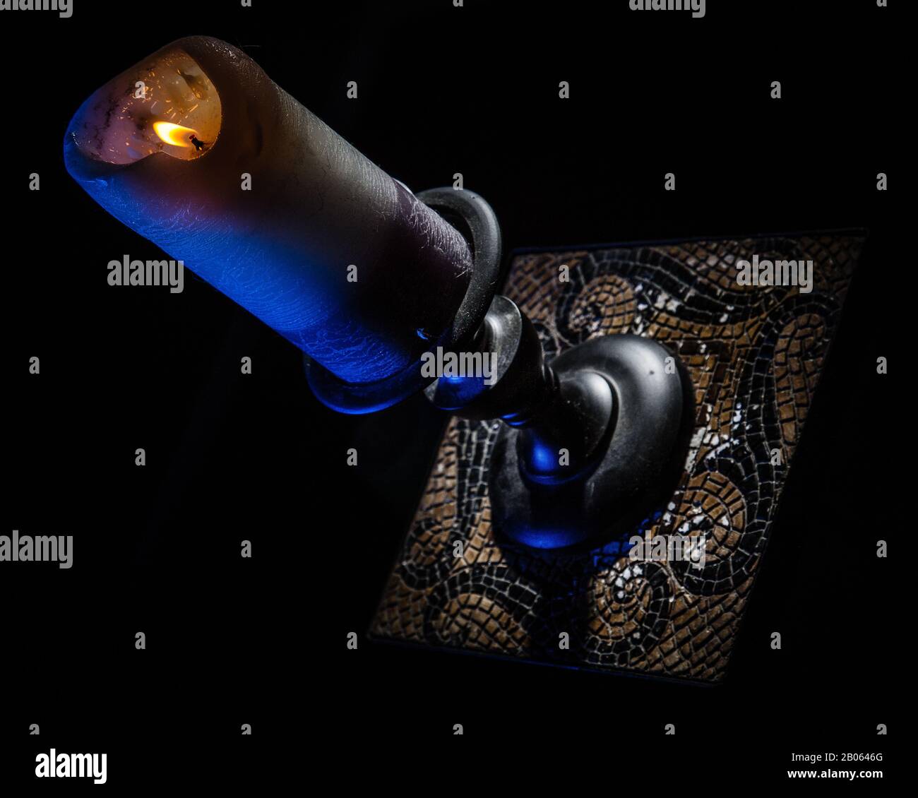 Scary Candle with Blue and Black Light and Yellow Flame Stock Photo - Alamy