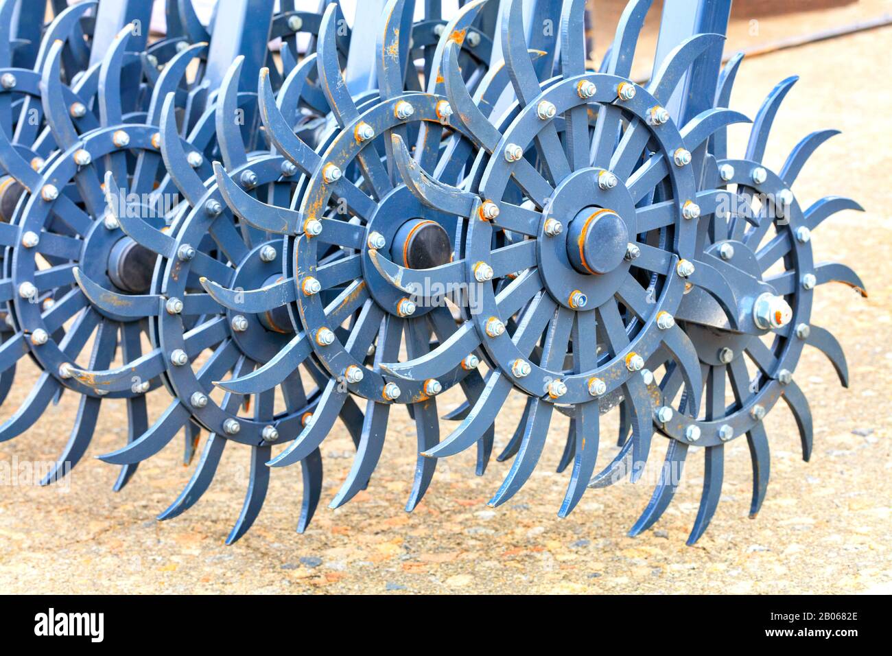 Blue metal toothed harrow as a tow hitch for a tractor for field ...