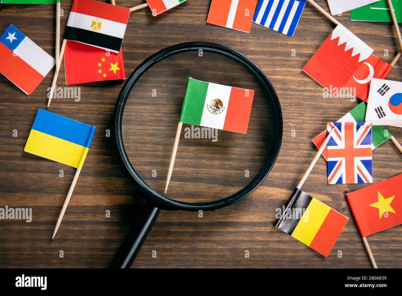 Mexican flag. Flags of many countries, magnifying glass on wooden table ...