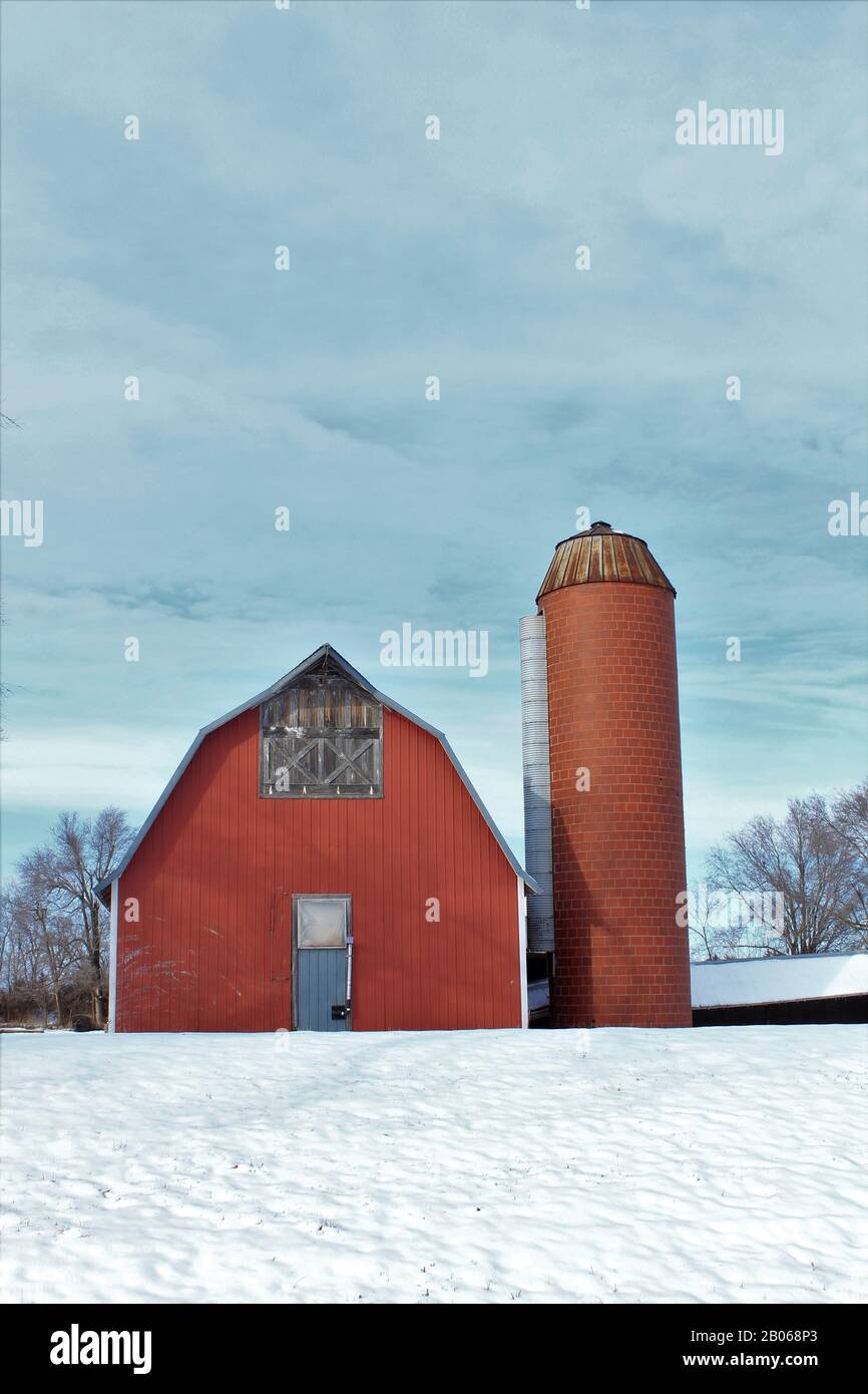 Kansas Red Country Barn with a silo in the winter time with snow out in ...