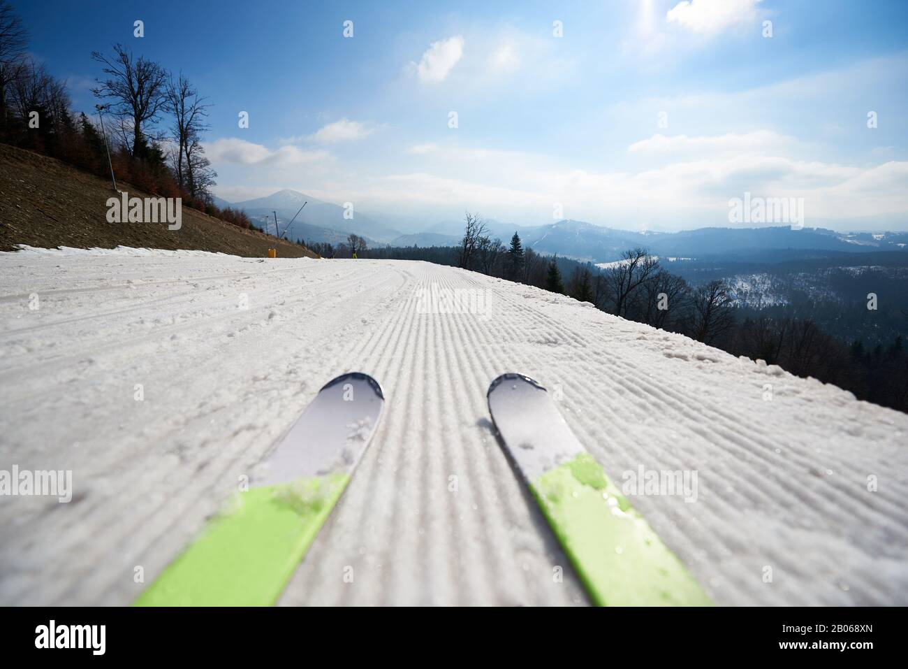 Close-up of skis on track, beautiful winter mountains range with white ...