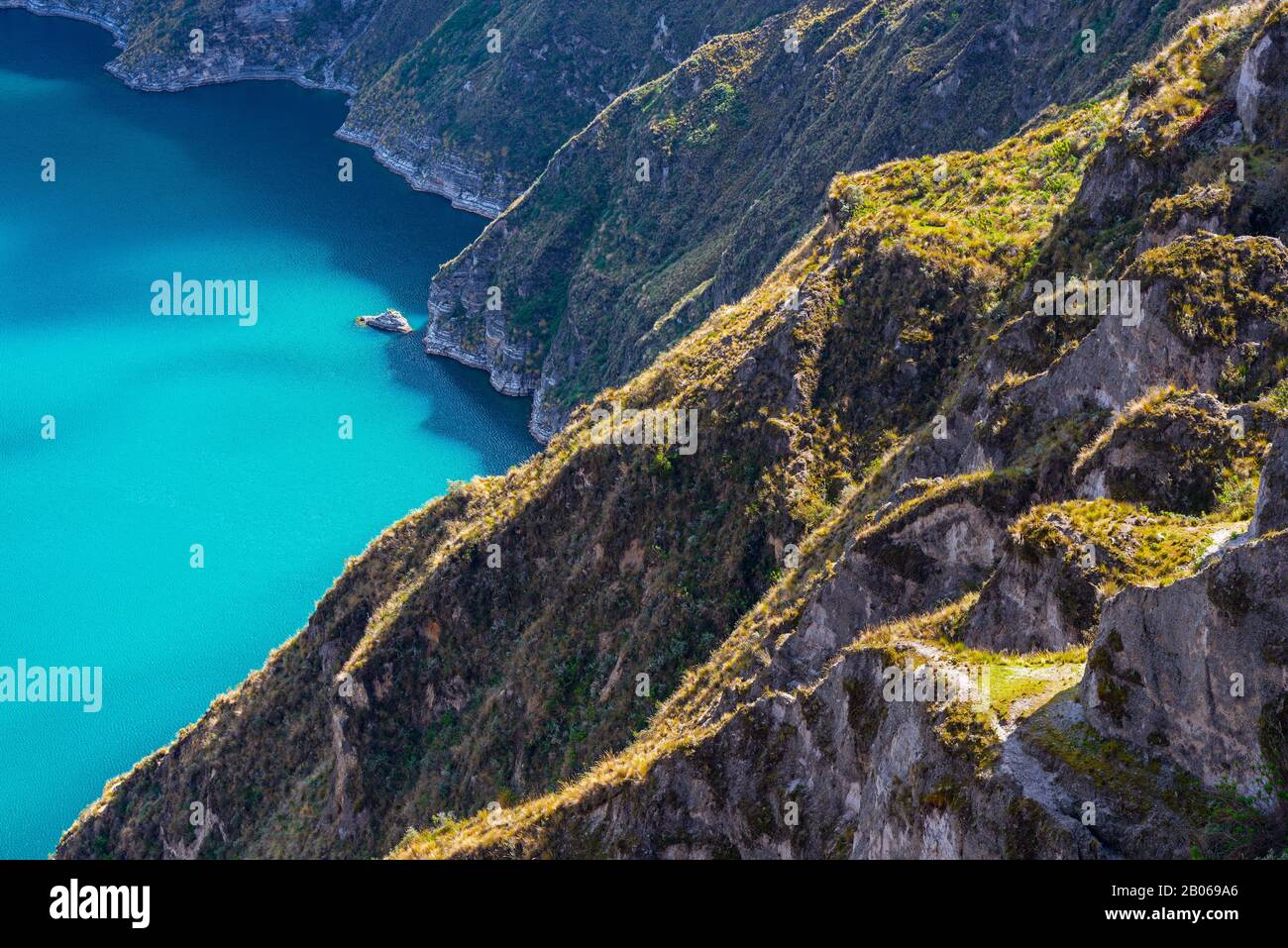 Cliffs with vegetation in the Andes mountains and the magic turquoise ...