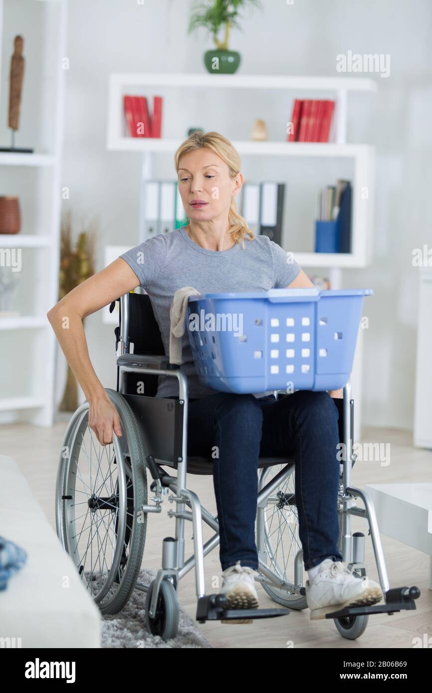 disabled young beautiful woman doing her laundry at home Stock Photo ...