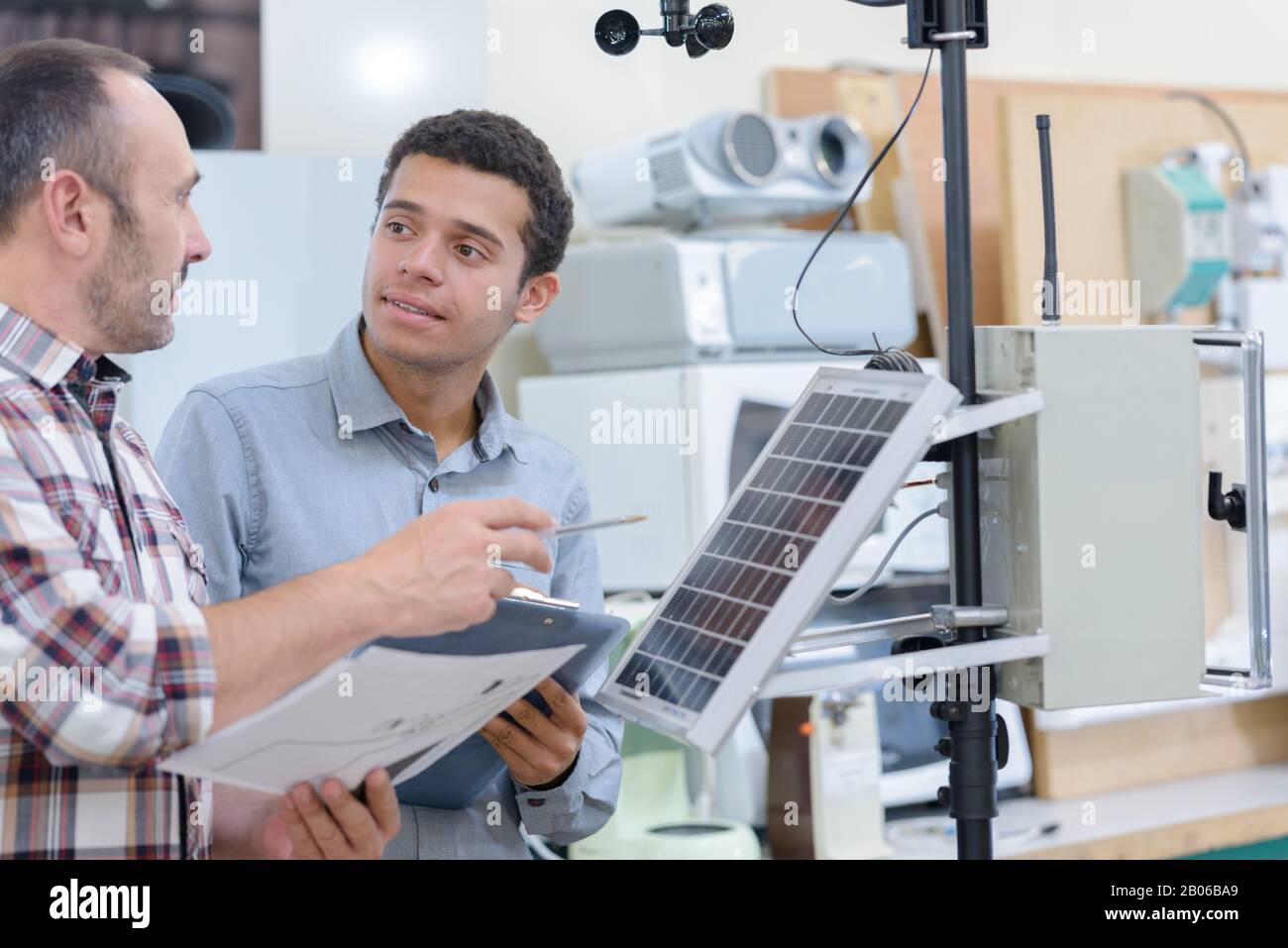 two people working on solar panels Stock Photo - Alamy
