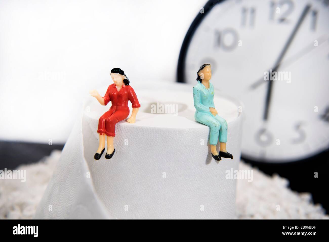 Abstract photo with toilet paper and some small people figures. Waste ...