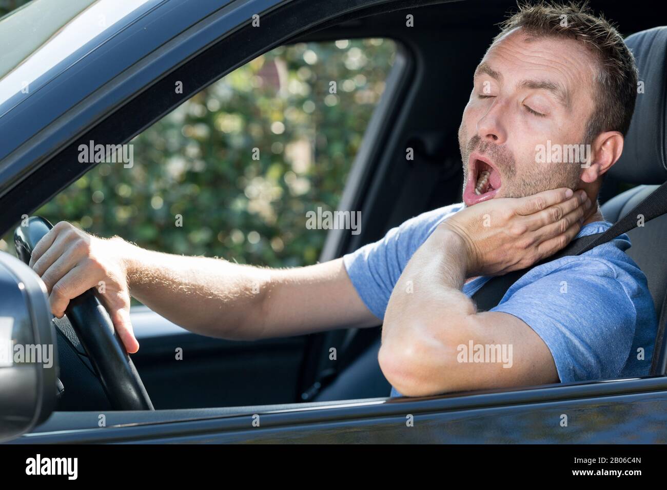 a sleepy man is driving Stock Photo - Alamy