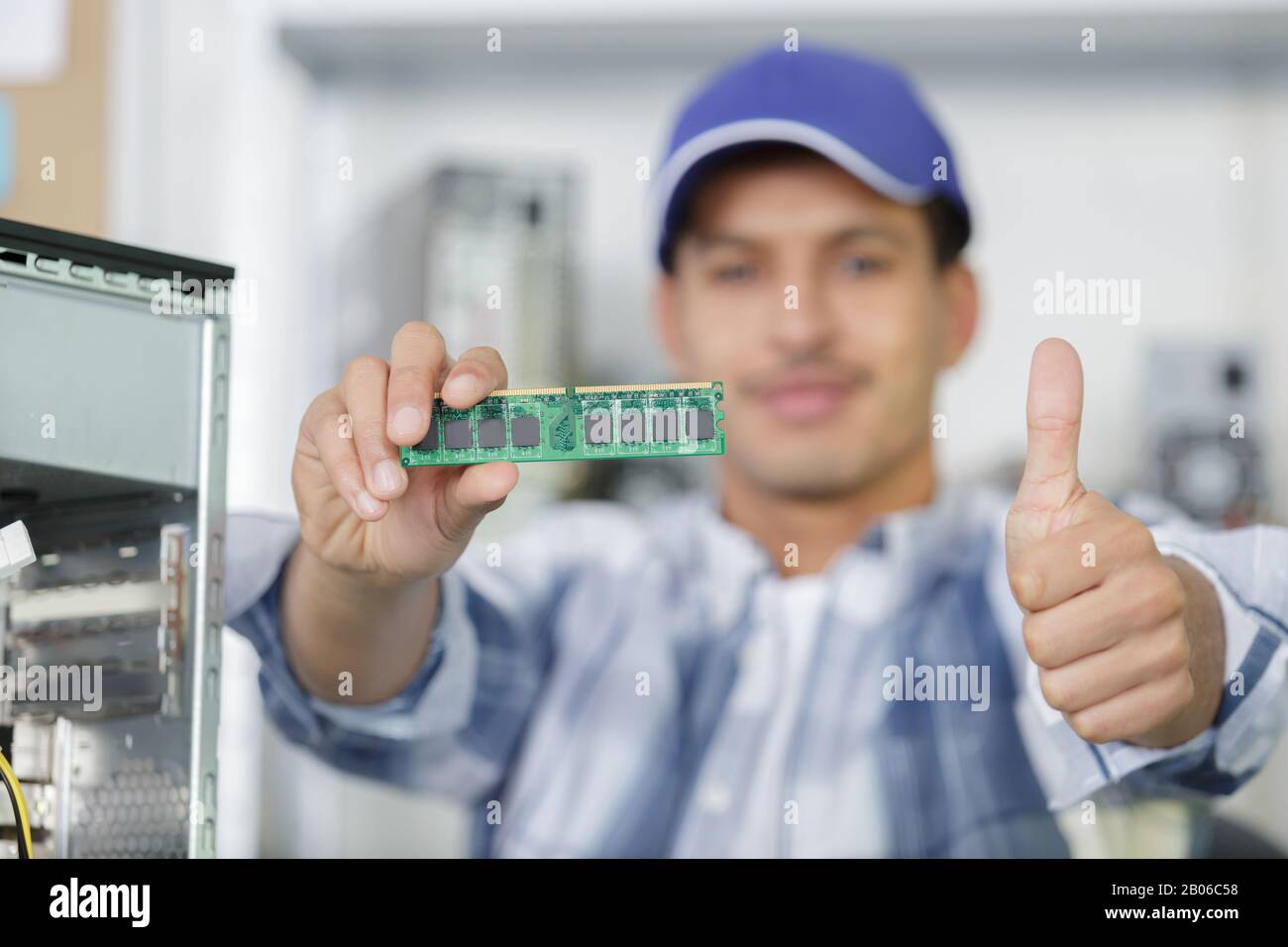 man showing thumb up while holding a pc component Stock Photo - Alamy