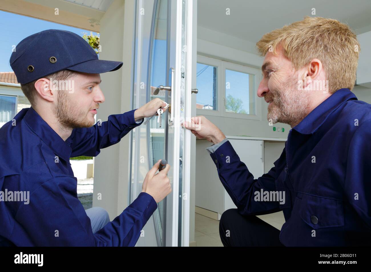 portrait of people during door installation Stock Photo - Alamy