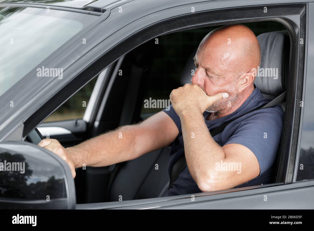 tired man in a car Stock Photo - Alamy