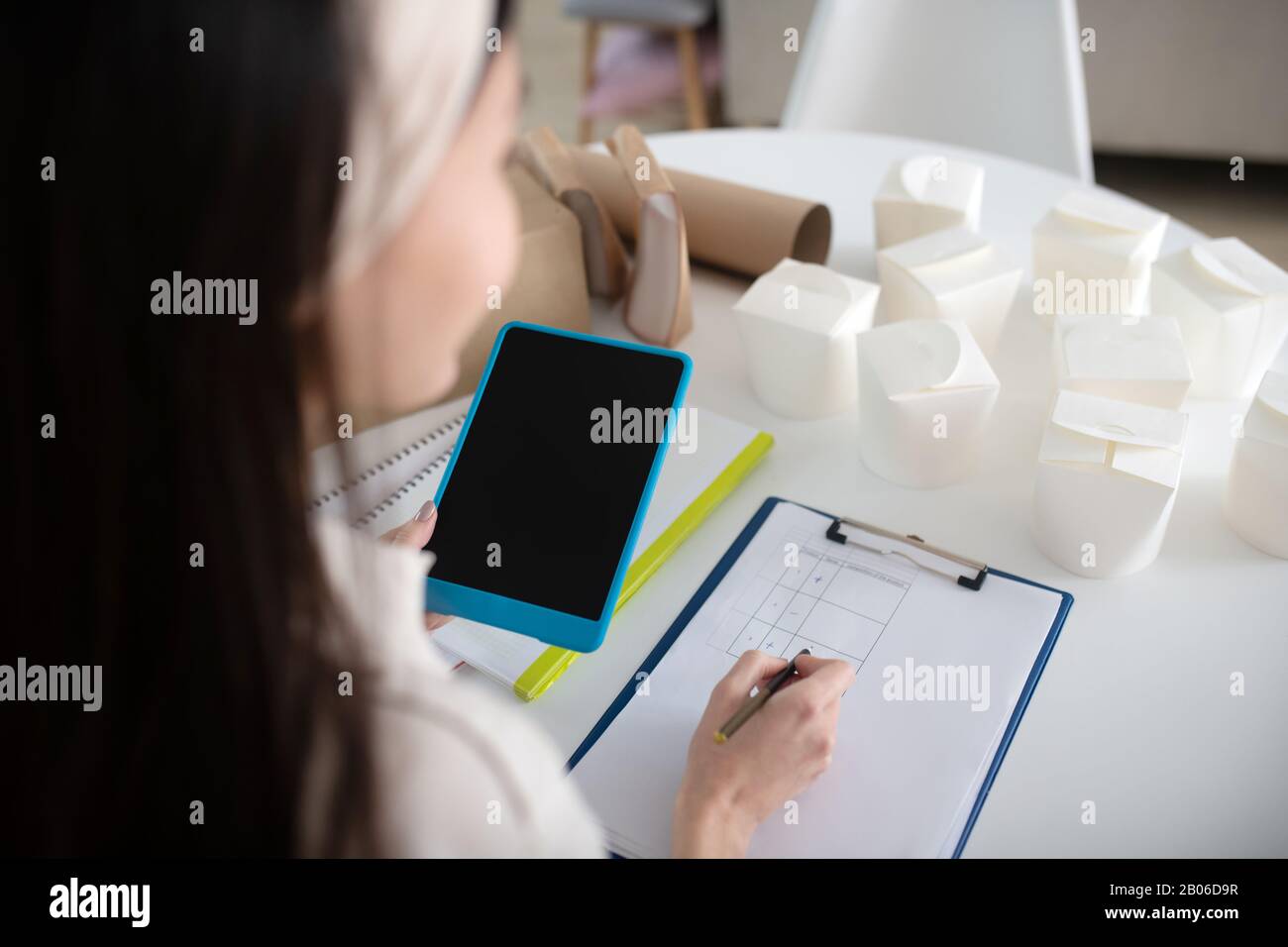 Woman working tablet taking notes hi-res stock photography and images ...