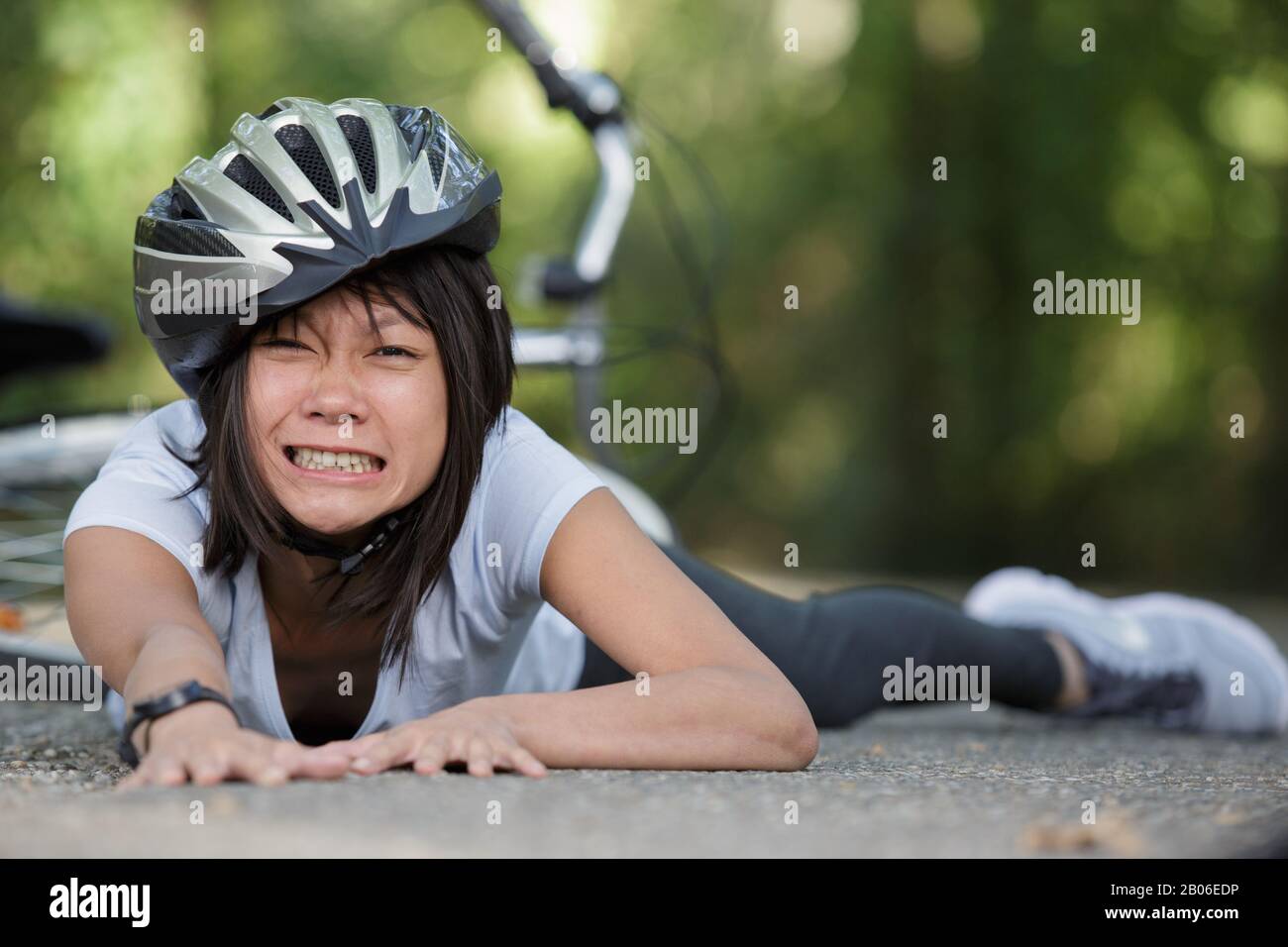 upset woman fell badly off her bicycle Stock Photo - Alamy