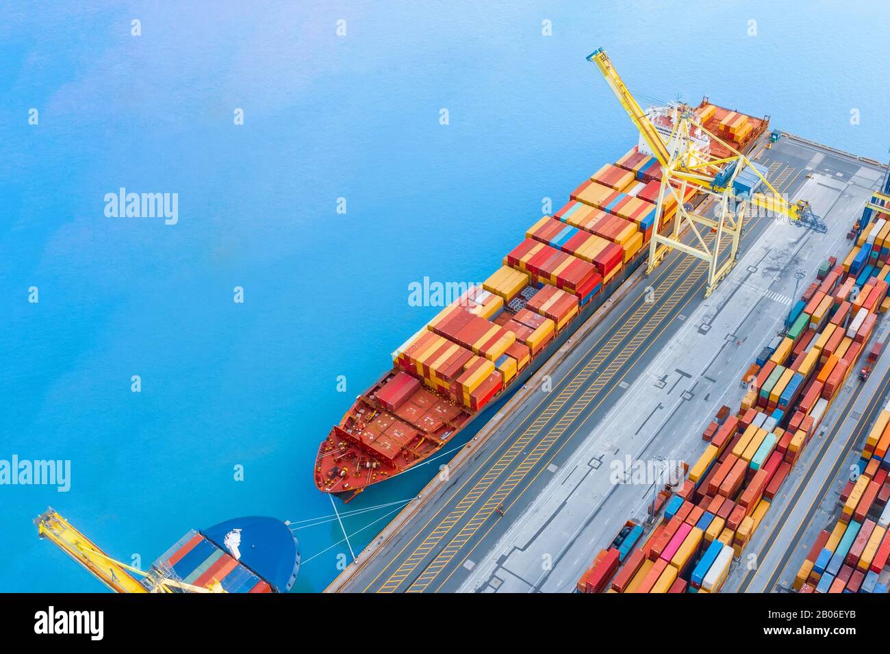 Ship with cargo containers at the marina of an industrial port, aerial ...
