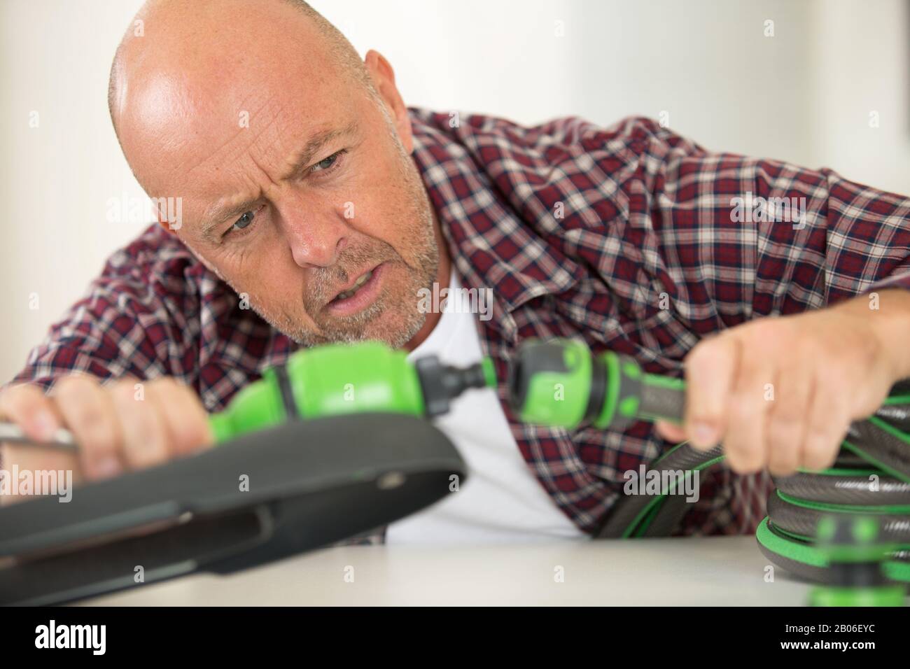 male worker and hose connection concept Stock Photo - Alamy