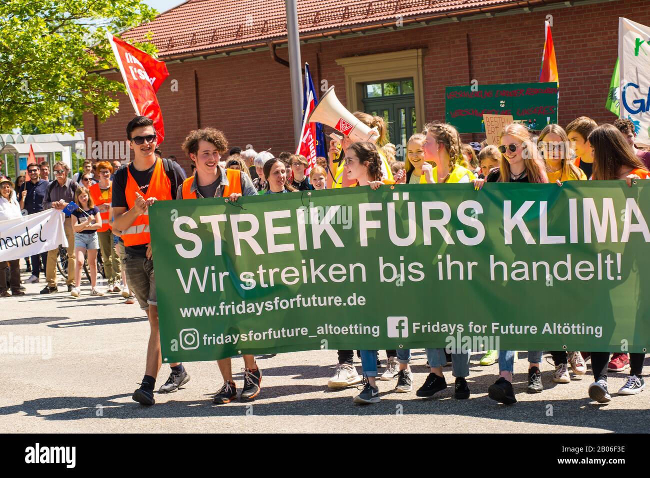 Youths holding different protest signs get ready for the rally to start ...