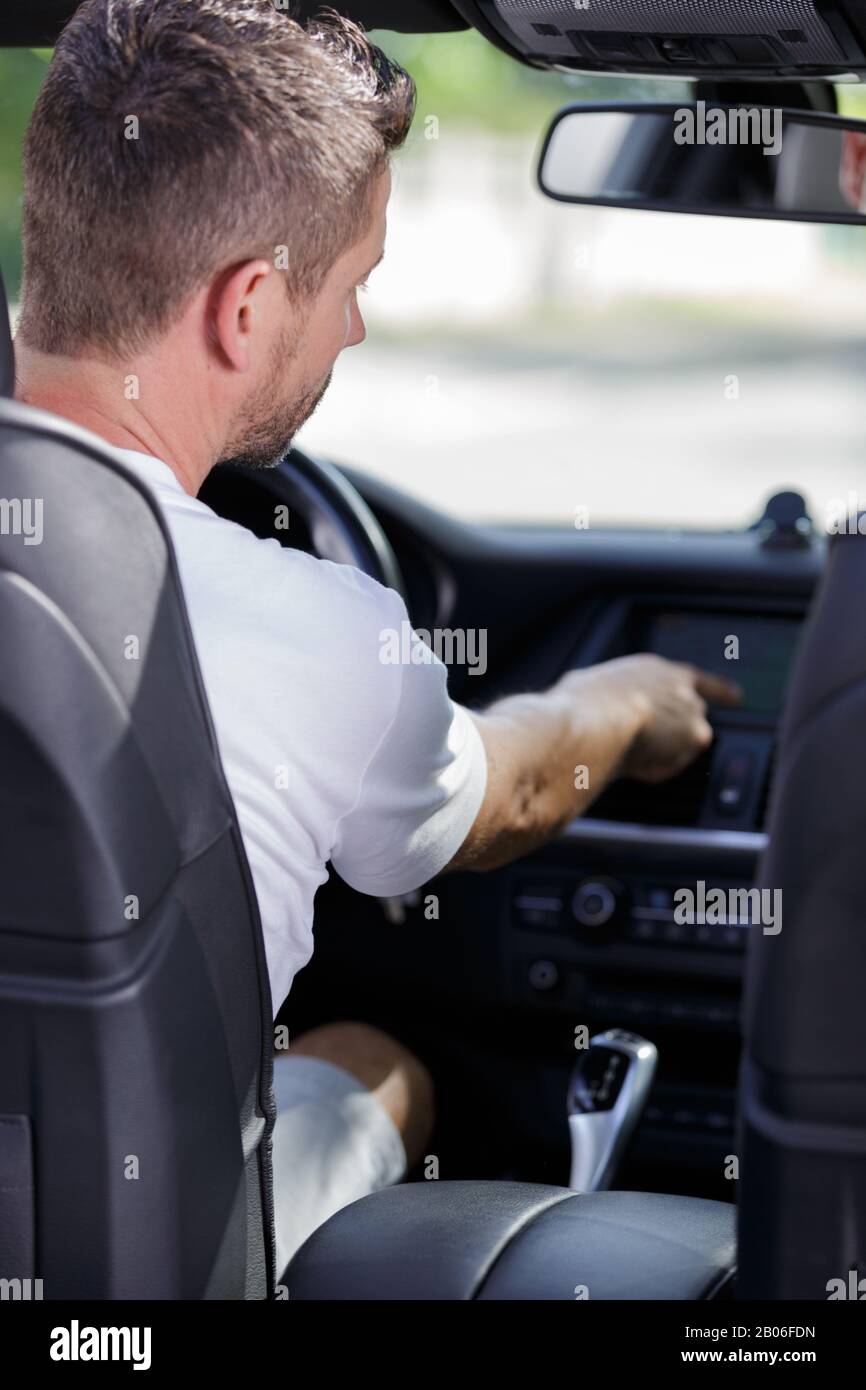 a man touching car dashboard Stock Photo - Alamy