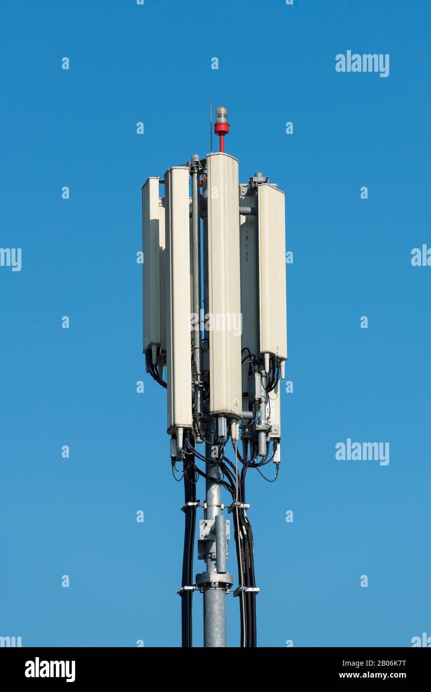 Mobile phone mast, transmission mast in front of blue sky, Germany ...