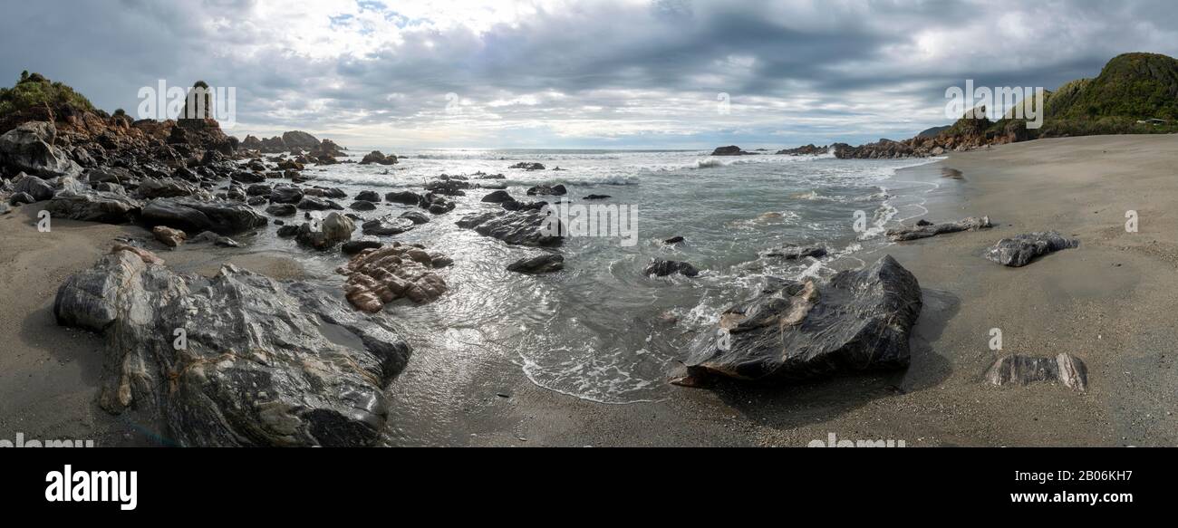 Rocky coast, rocks on the beach, dark rain clouds, long time exposure ...