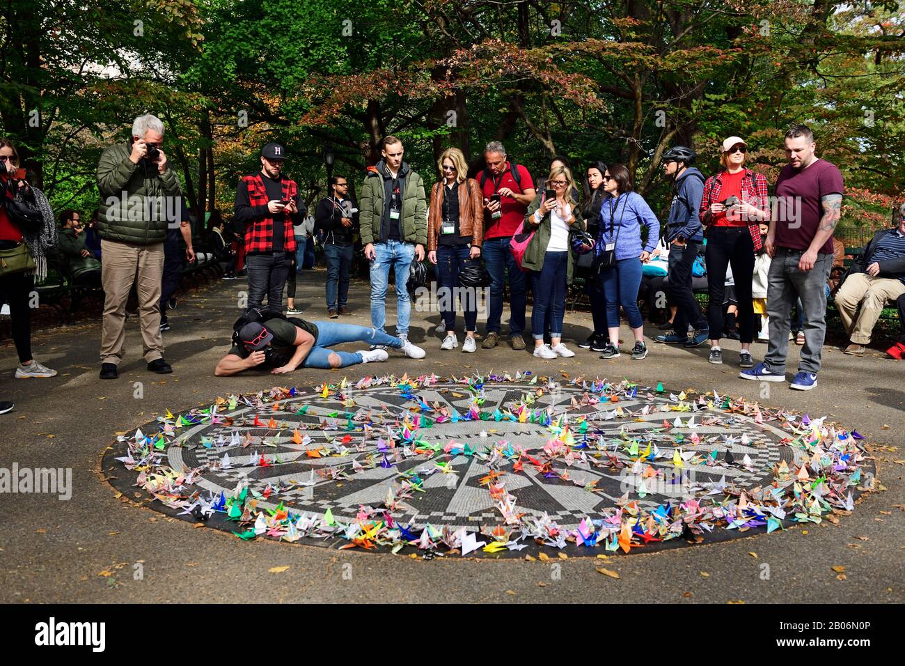 Tourists photograph the John Lennon Memorial, Strawberry Fields ...