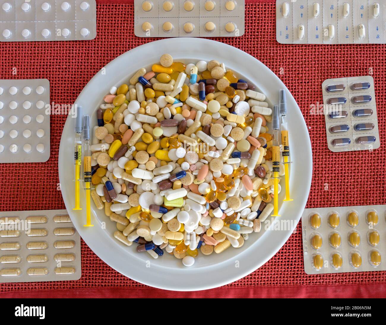 Symbol picture drug abuse, plate with tablets and syringes, Germany ...