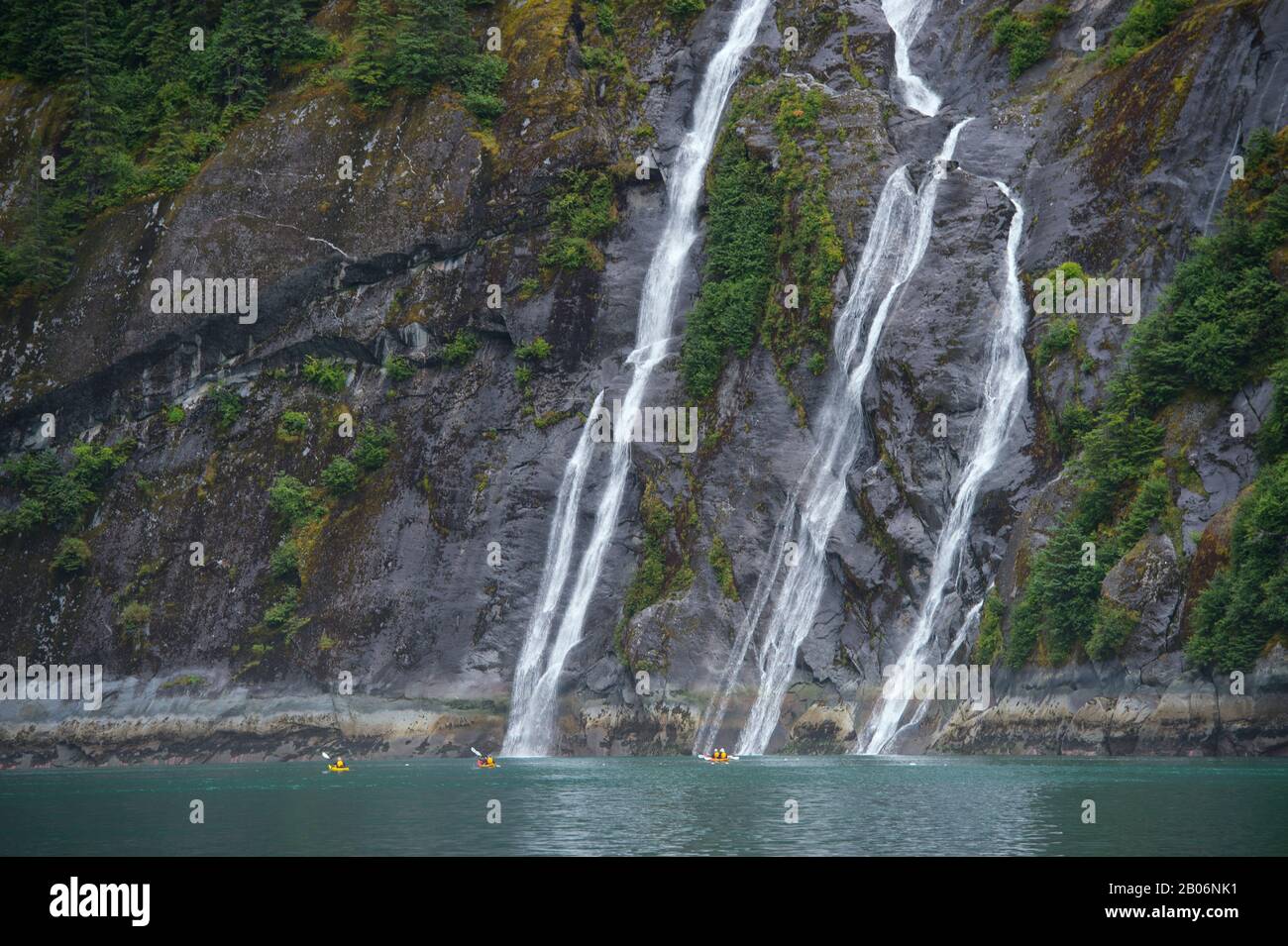 People sea kayaking in front of waterfall at Fords Terror, Endicott Arm ...